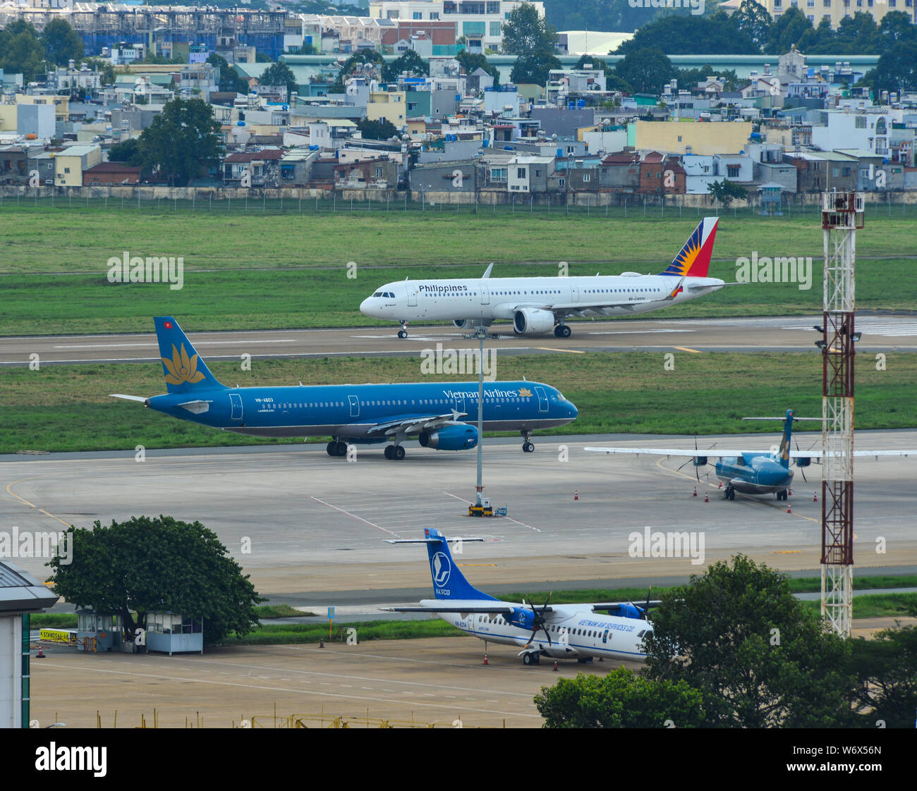 Saigon, Vietnam - Jul 13, 2019. Passenger airplanes taxiing on runway ...
