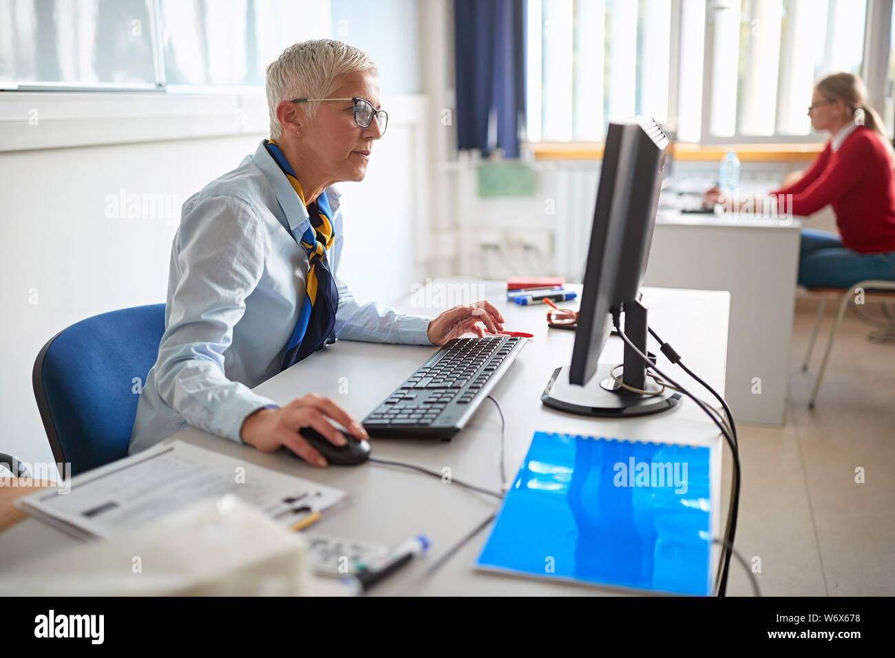 Teacher lecturer on class with students working on computer on ...