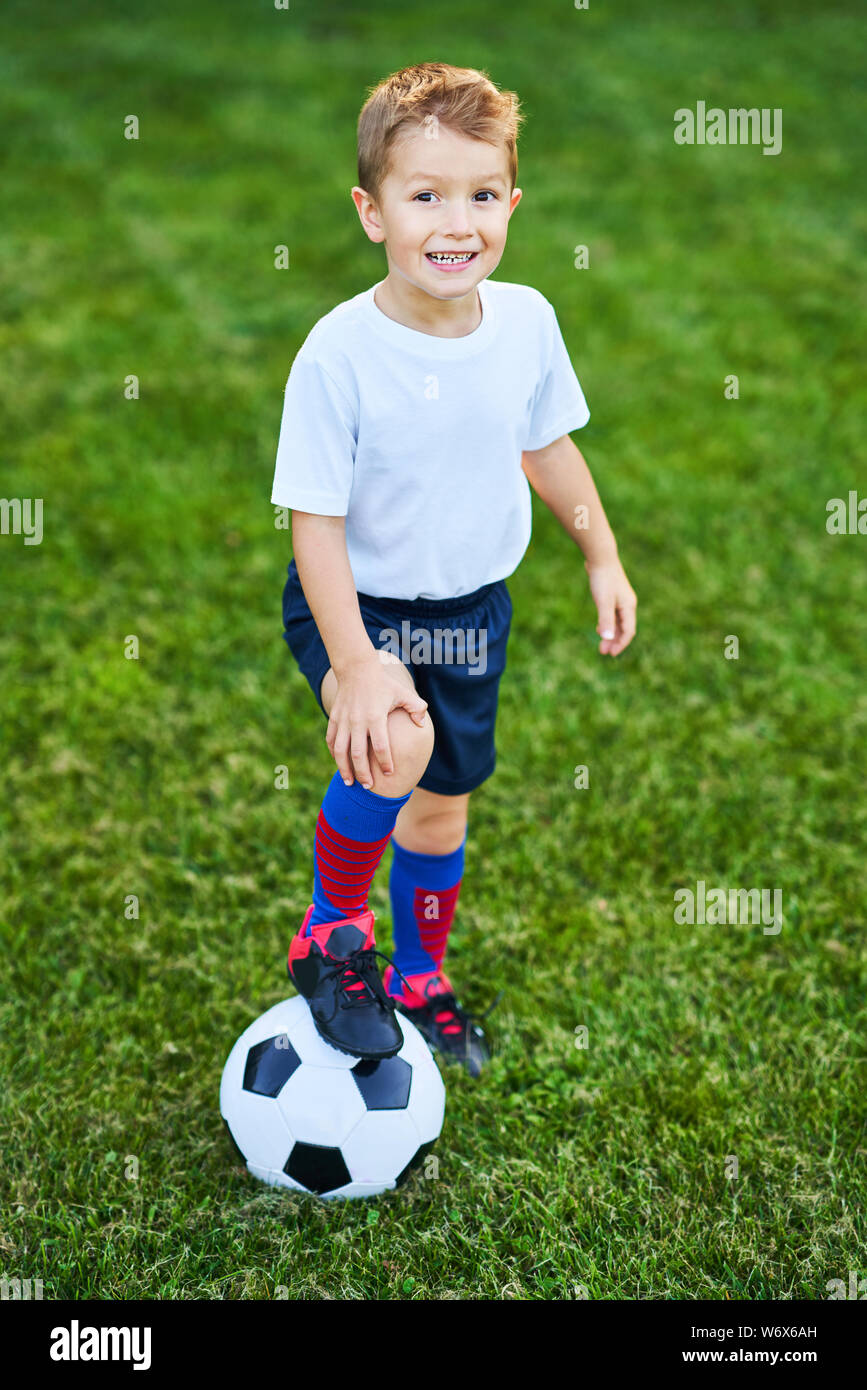 Little Boy practising football outdoors Stock Photo - Alamy
