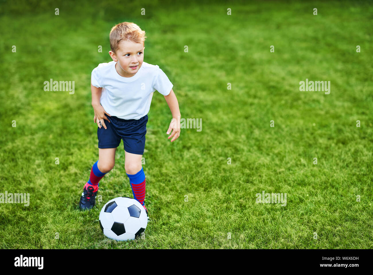 Little Boy practising football outdoors Stock Photo - Alamy