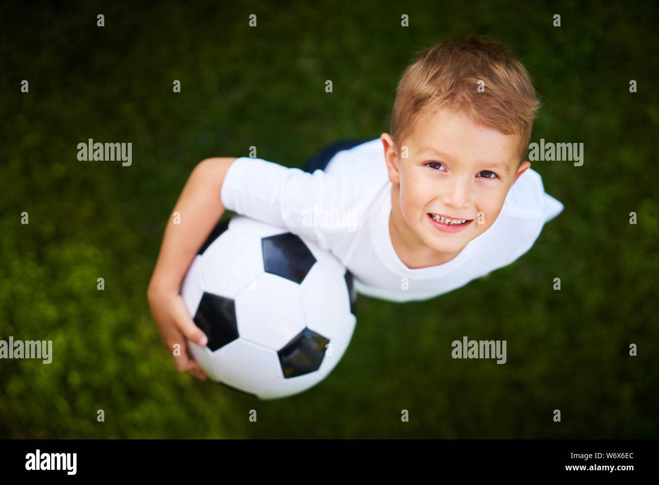 Little Boy practising football outdoors Stock Photo - Alamy