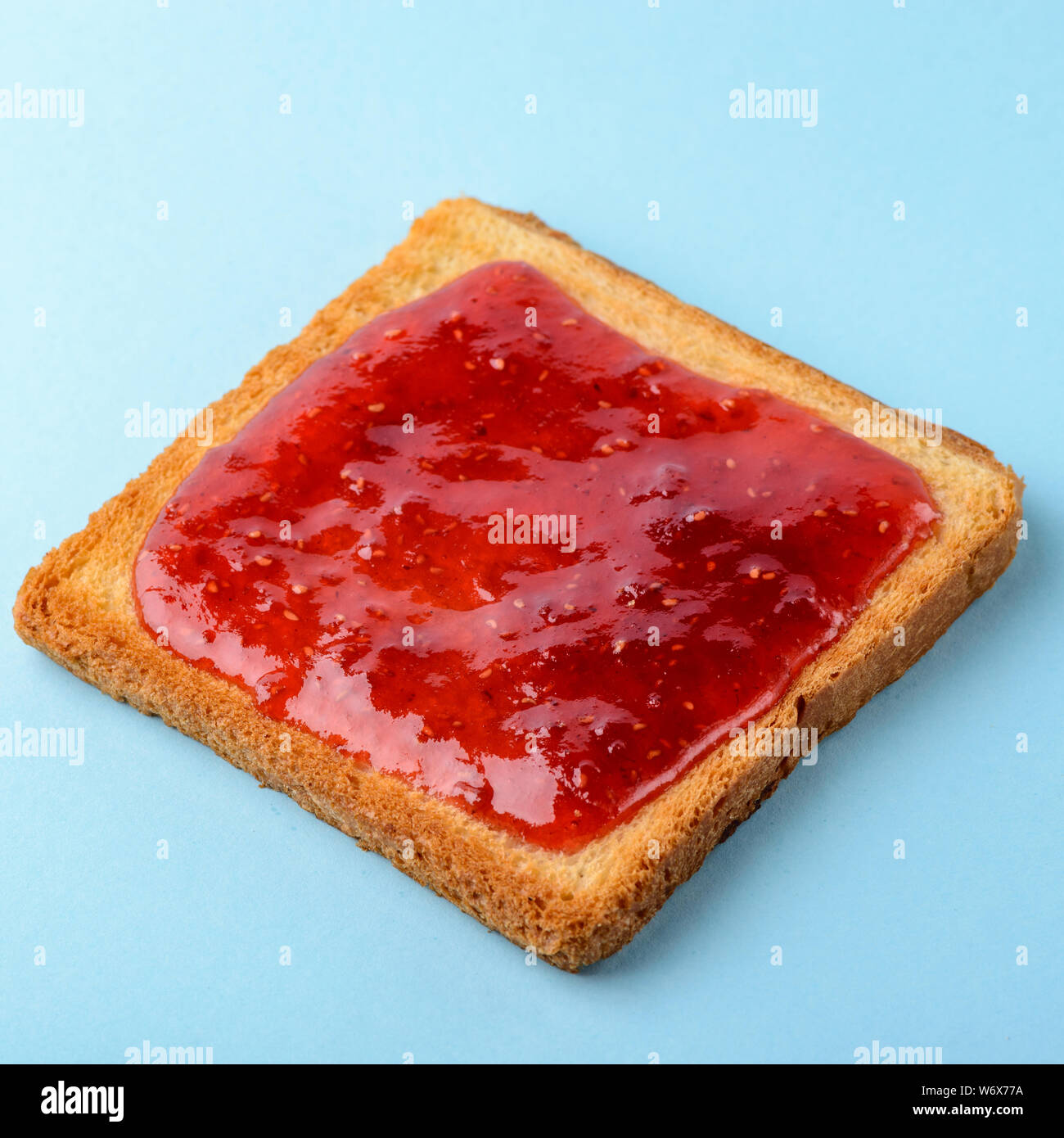 Toast with raspberry jam Stock Photo - Alamy