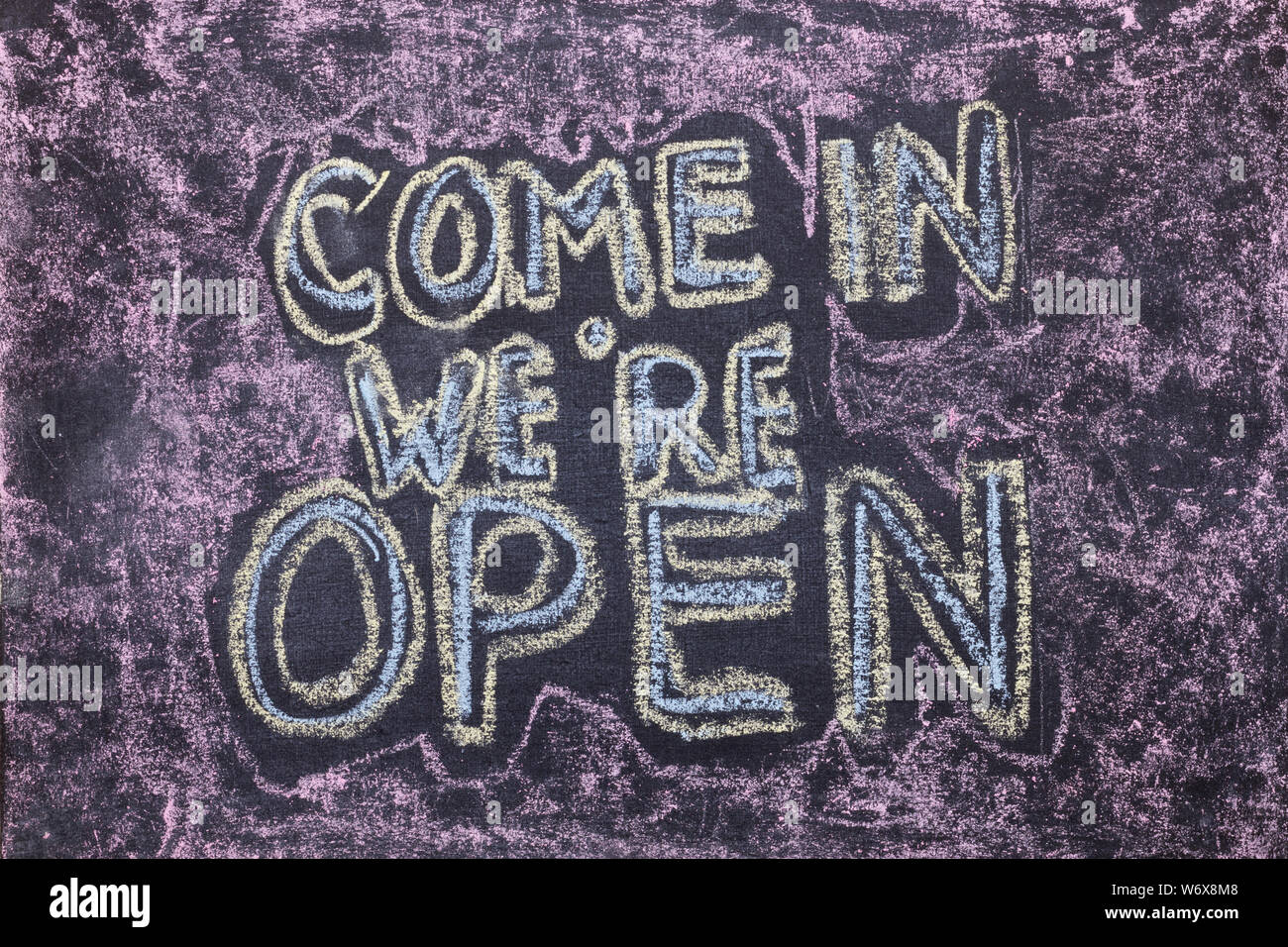 Come in we're open. Chalk lettering on blackboard. Multi colored ...