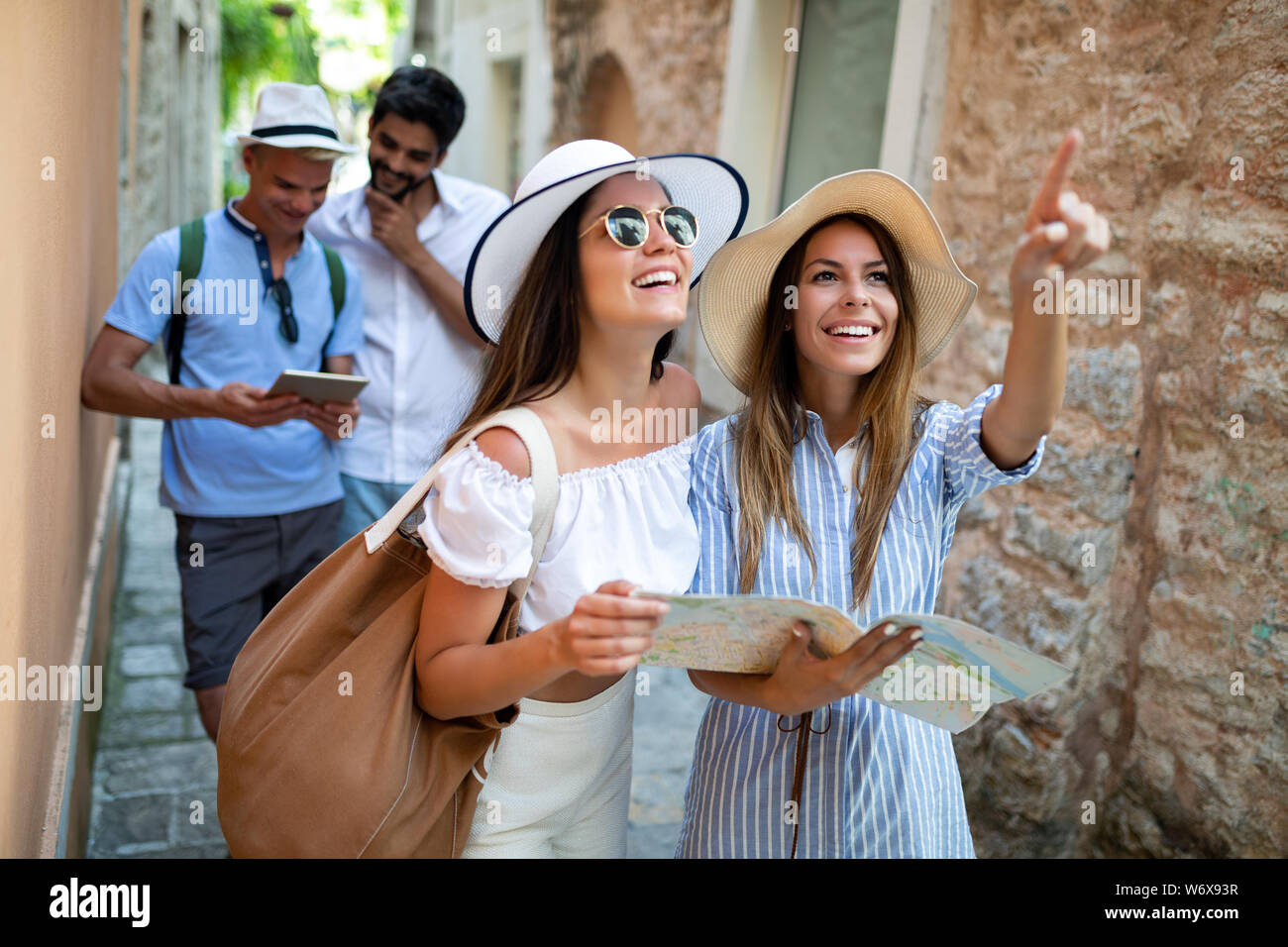 Happy group of friends tourists sightseeing in city on vacation Stock ...