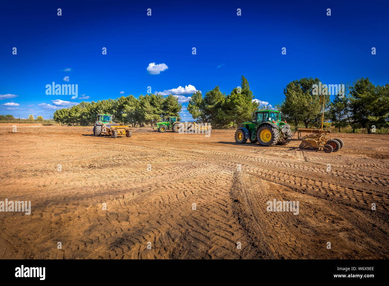 Tractors leveling in the field Stock Photo - Alamy