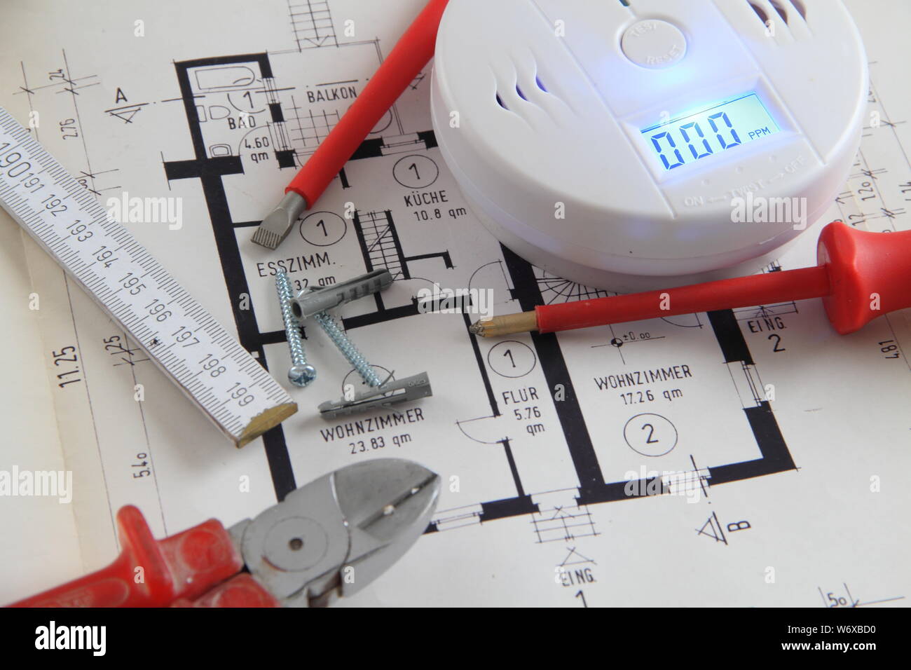 a co-detector with tools on a blueprint Stock Photo - Alamy