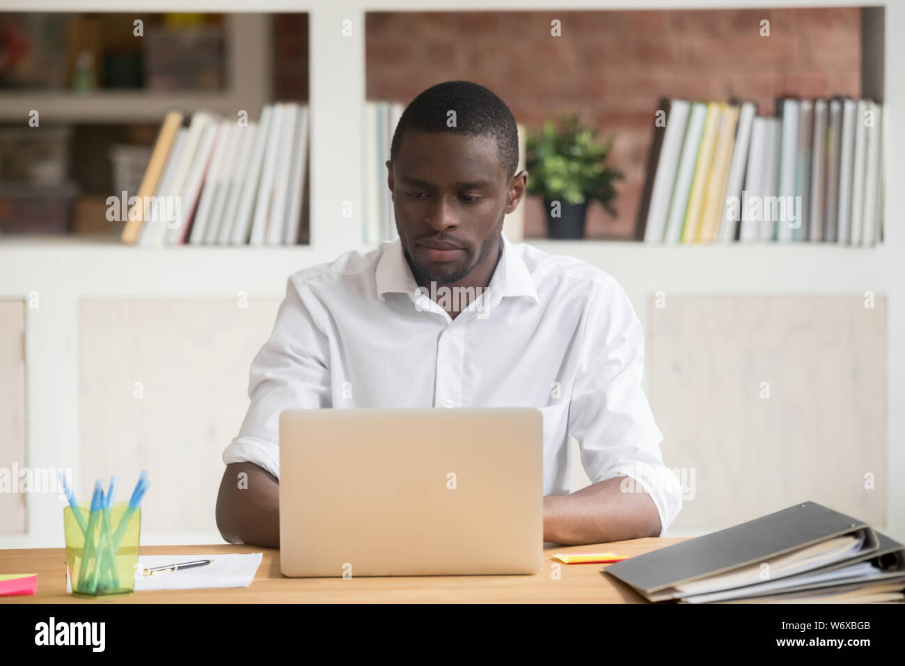 Businessman sitting desk typing hi-res stock photography and images - Alamy