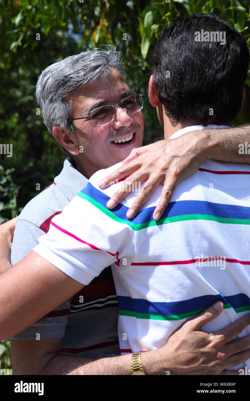 Rear view of parents hugging child hi-res stock photography and images ...