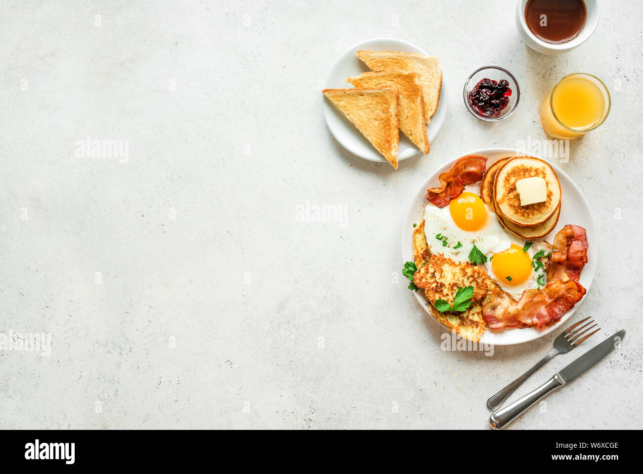 Full American Breakfast on white, top view, copy space. Sunny side ...