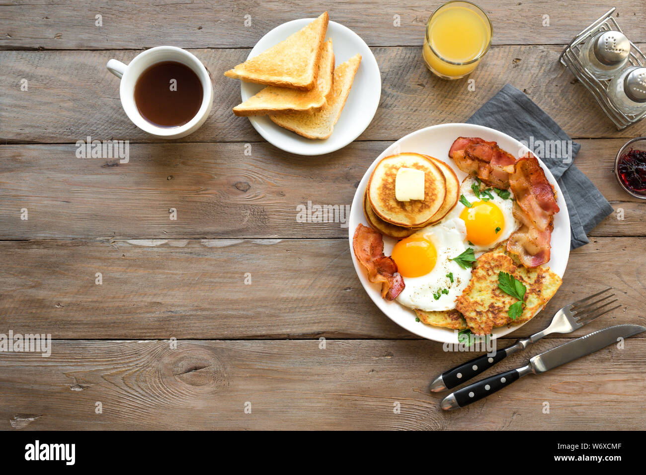 Full American Breakfast on wooden, top view, copy space. Sunny side ...