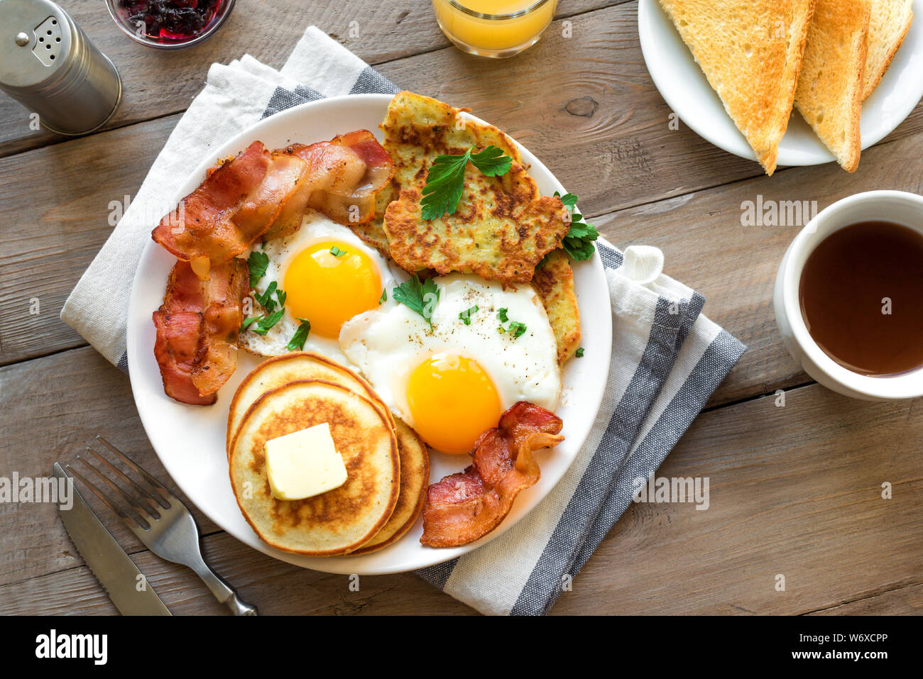 Full American Breakfast on wooden, top view. Sunny side fried eggs ...
