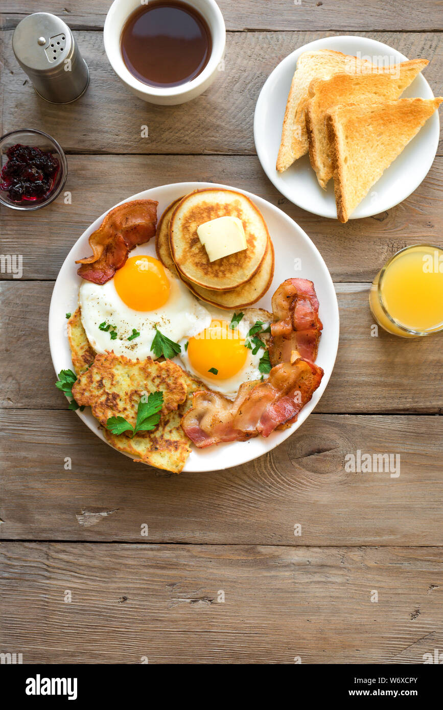 Full American Breakfast on wooden, top view, copy space. Sunny side ...