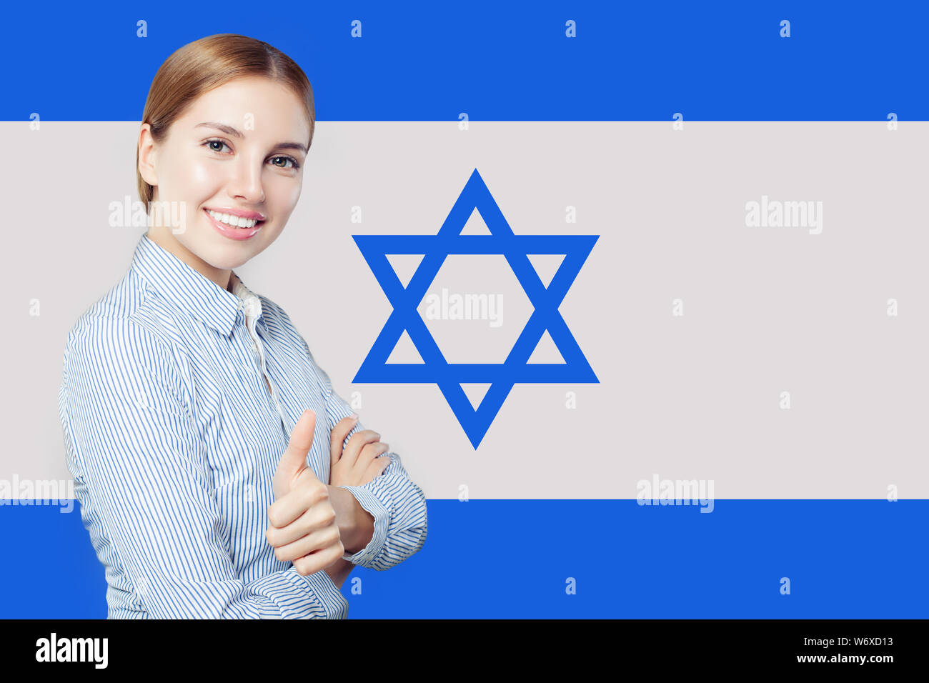 Cute happy young woman against the Israel flag background. Live ...