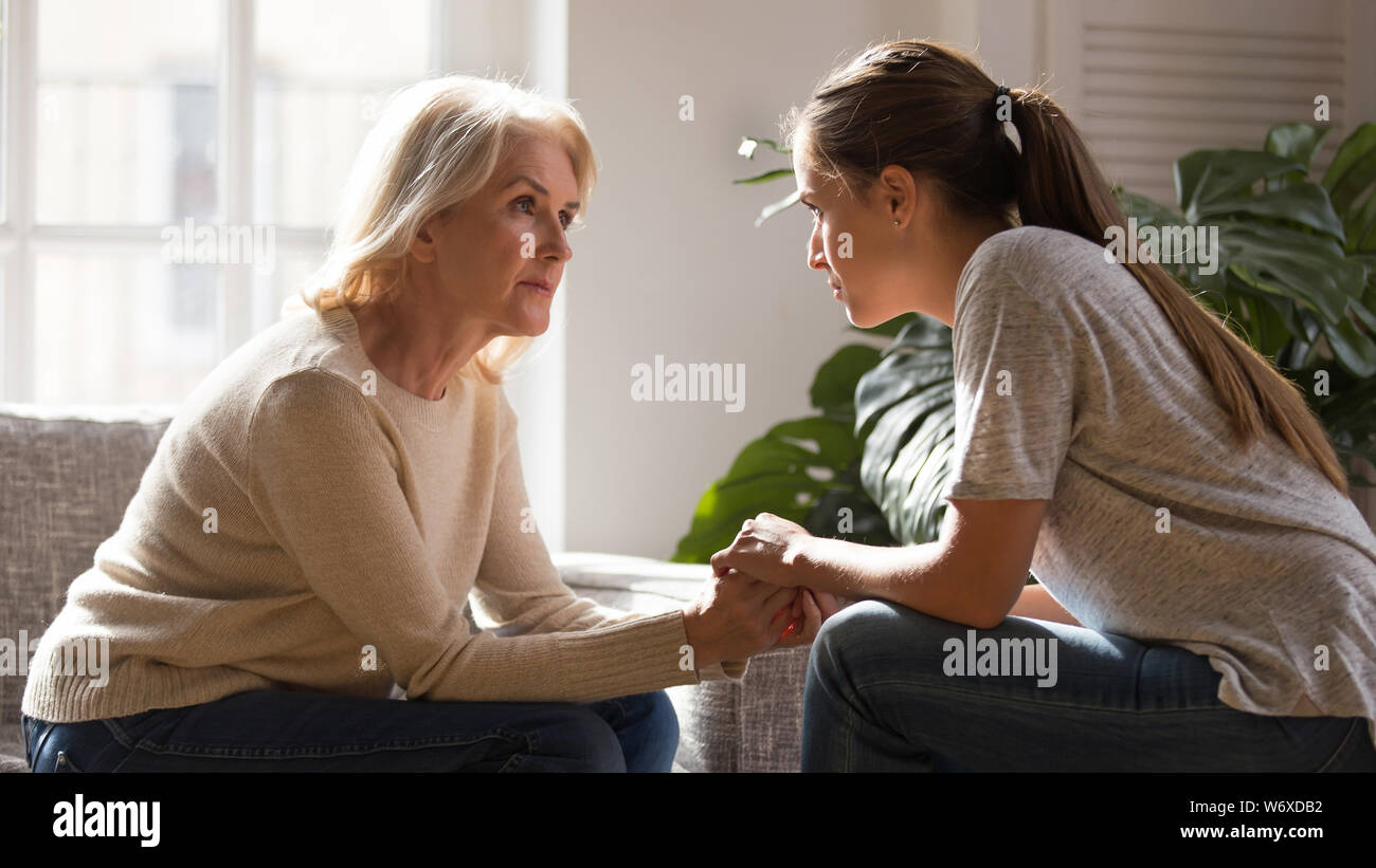 Different generations women talking holding hands giving psychological ...