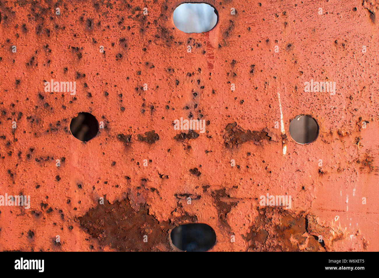 Old weathered rusty iron plank surface with holes closeup as grunge ...