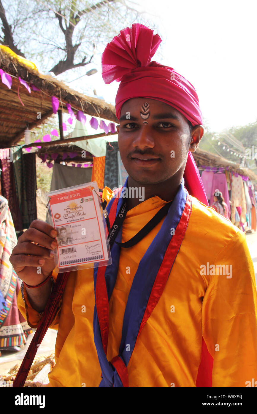 Shopkeeper showing his ID card, Surajkund Crafts Mela, Surajkund ...