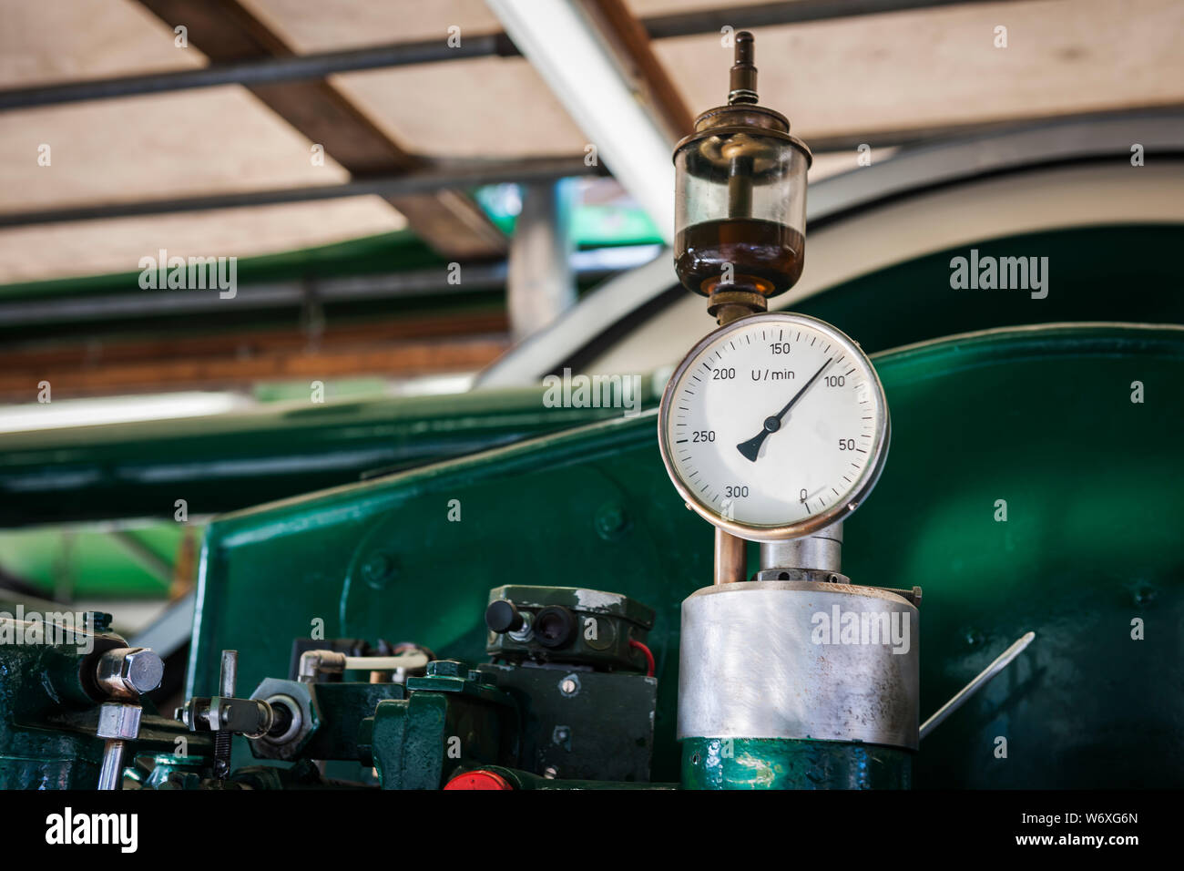 Tachometer with oil droplets mounted next to it on an old restored ...