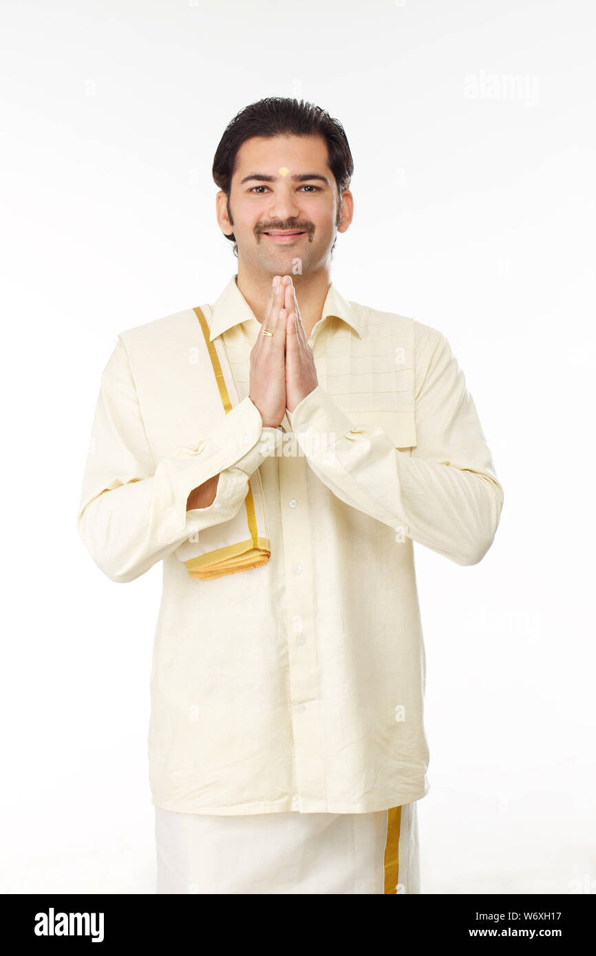 South Indian man standing with hands joined Stock Photo - Alamy