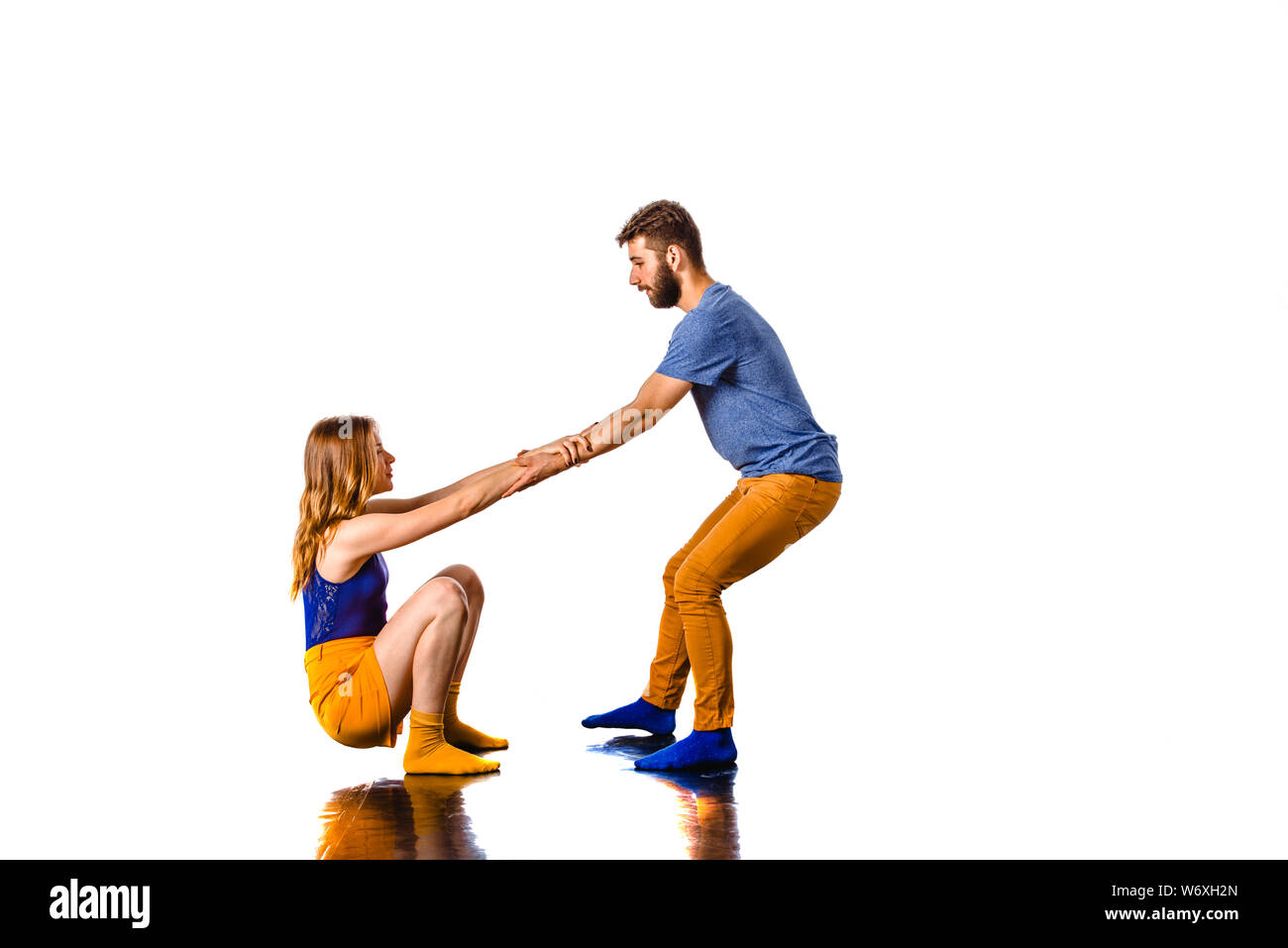 Romantic couple dancing together in studio, isolated on white ...