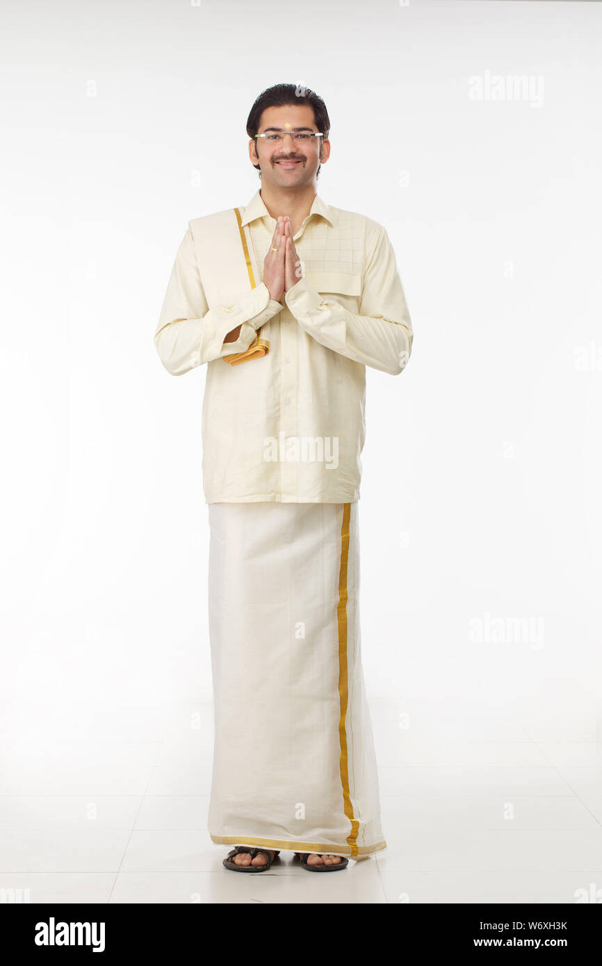 South Indian man standing with hands joined Stock Photo - Alamy