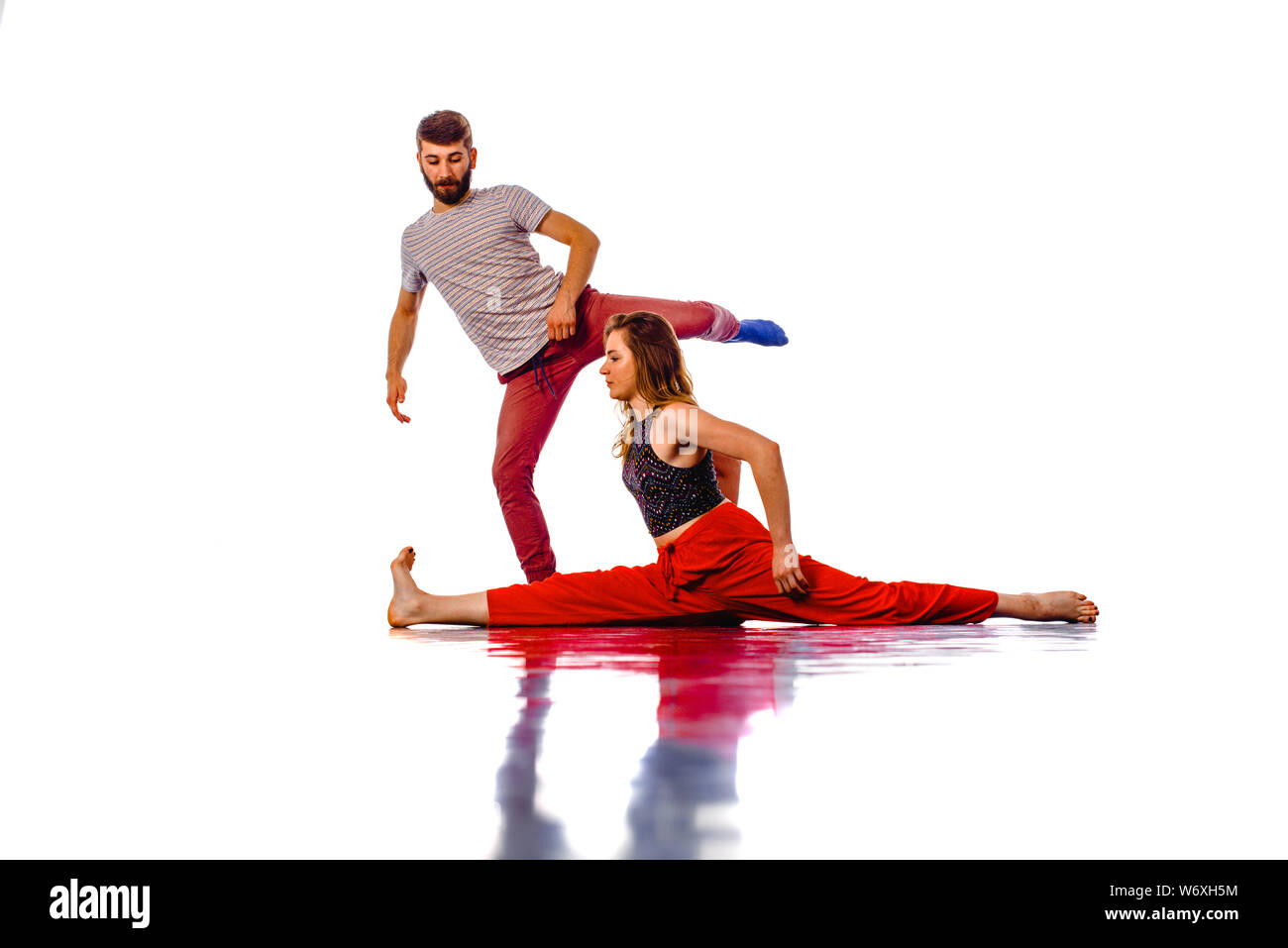Romantic couple dancing together in studio, isolated on white ...