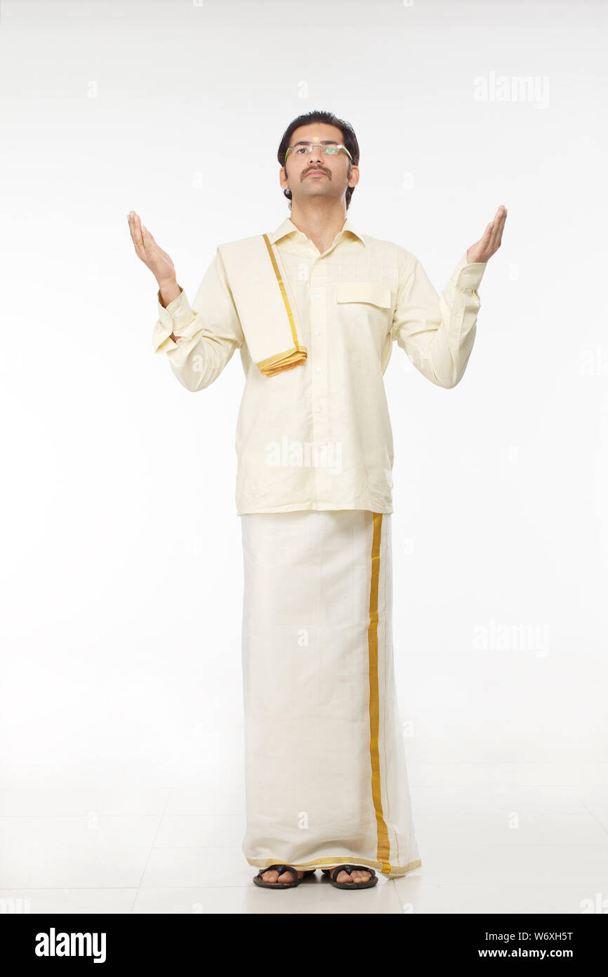 South Indian man standing with his arm outstretched Stock Photo - Alamy