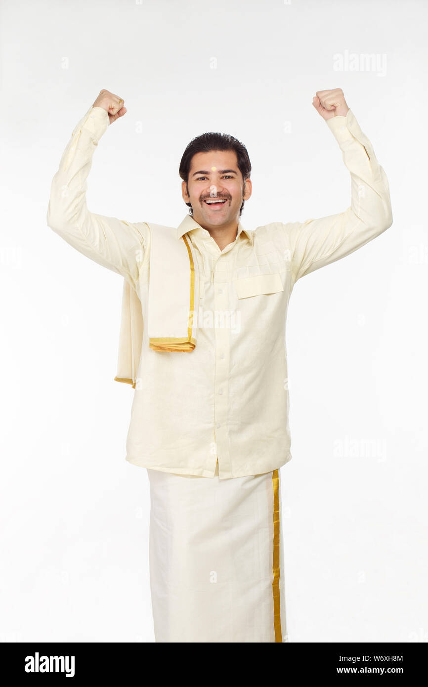 South Indian man smiling with his arm outstretched Stock Photo - Alamy