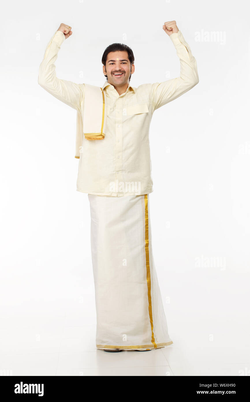 South Indian man smiling with his arm outstretched Stock Photo - Alamy