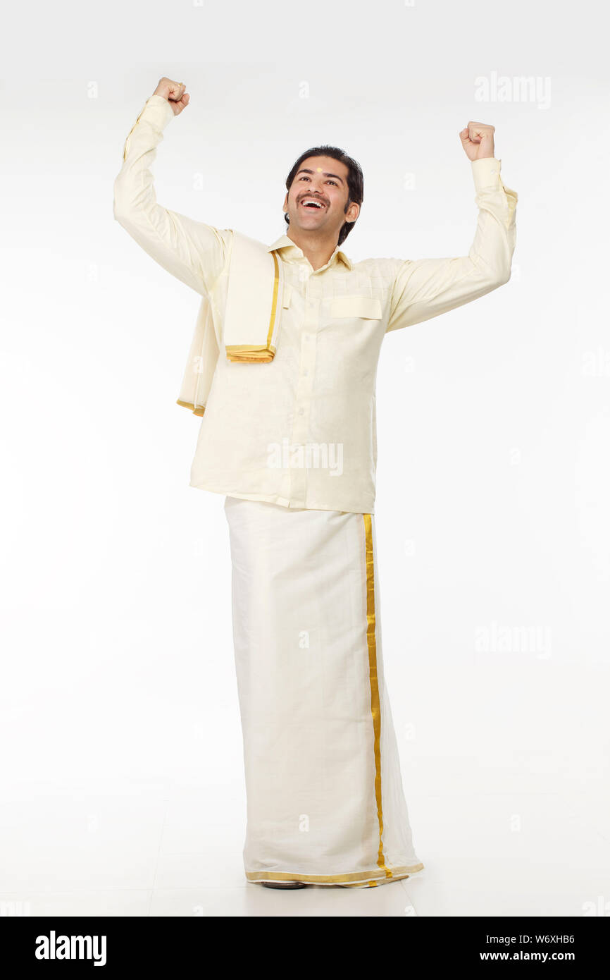 South Indian man smiling with his arm outstretched Stock Photo - Alamy
