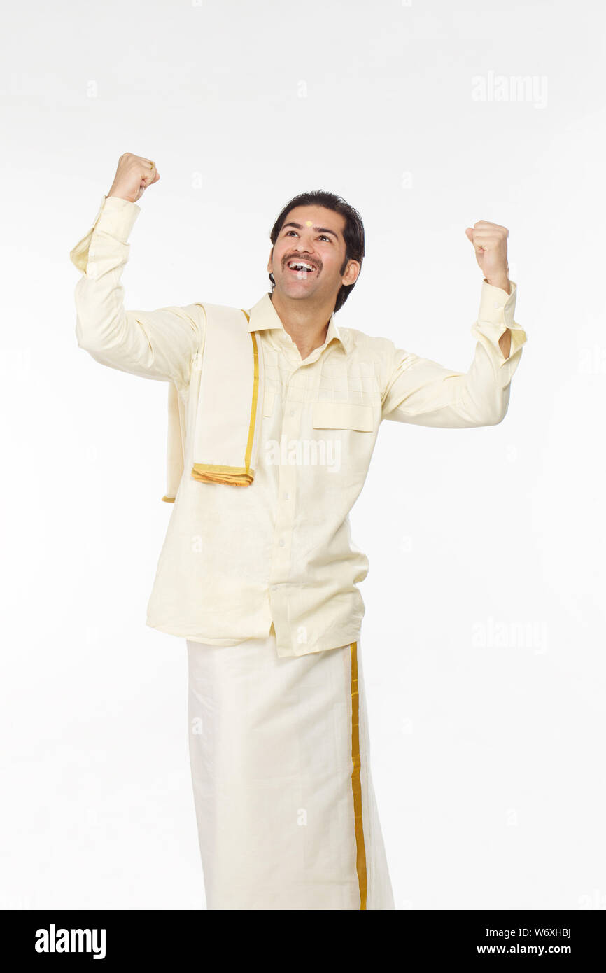 South Indian man smiling with his arm outstretched Stock Photo - Alamy
