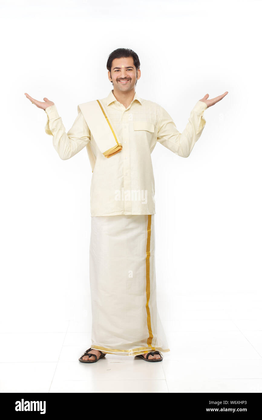 South Indian man smiling with his arm outstretched Stock Photo - Alamy