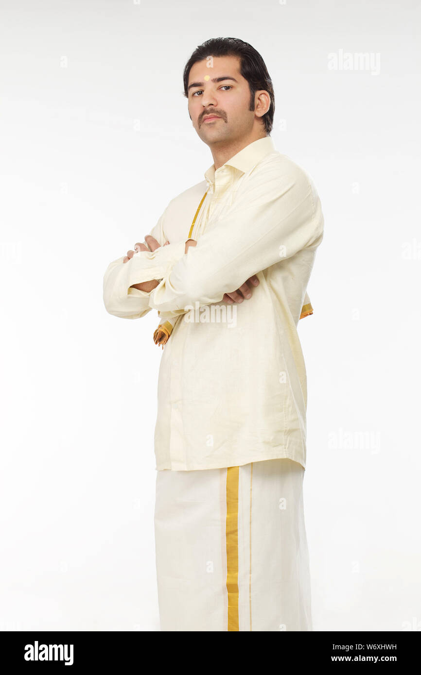 South Indian man standing with his arms crossed Stock Photo - Alamy