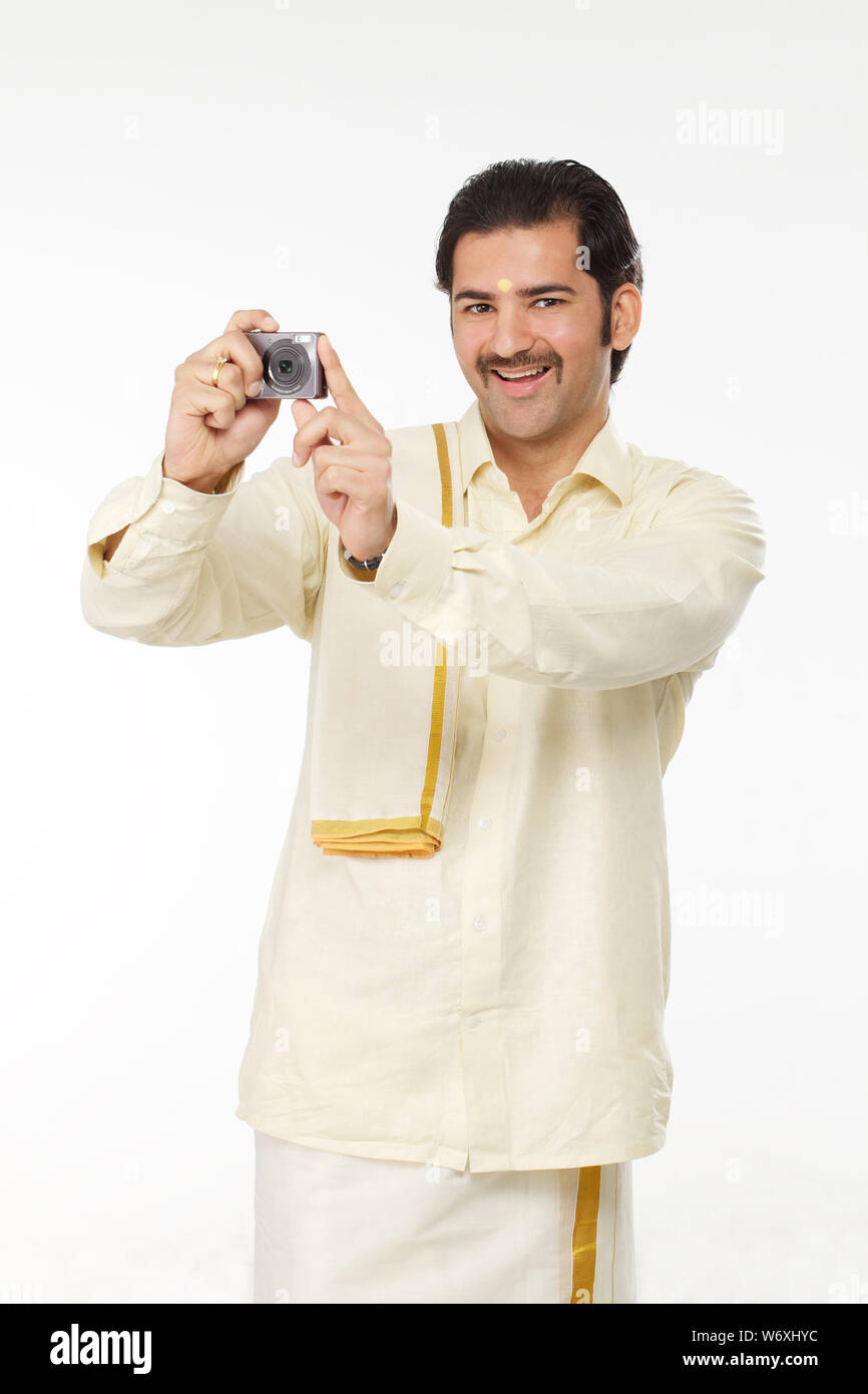 South Indian man taking picture with digital camera Stock Photo - Alamy