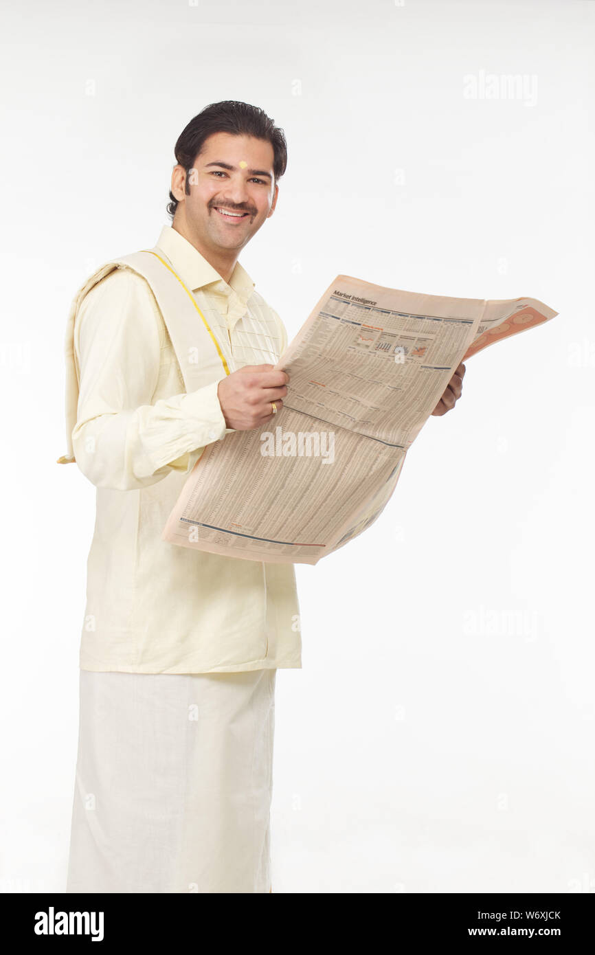 South Indian man reading a newspaper Stock Photo - Alamy