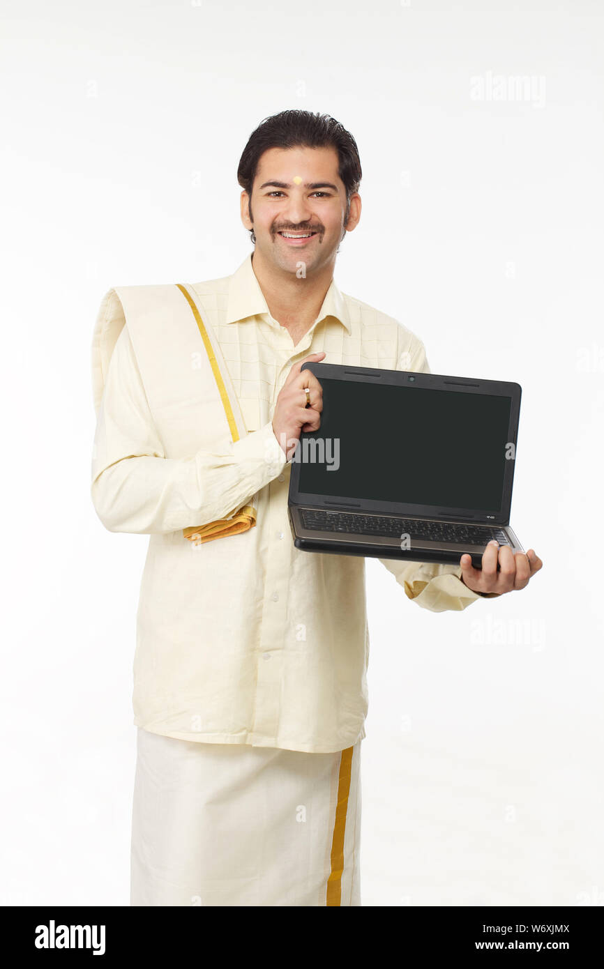 South Indian man showing a laptop Stock Photo - Alamy