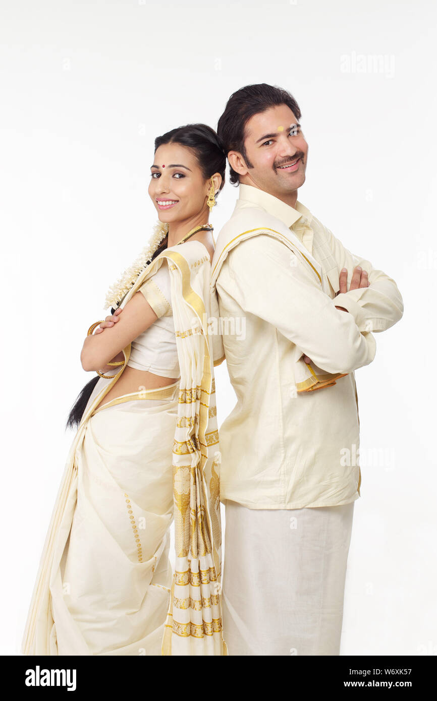 South Indian couple standing back to back Stock Photo - Alamy