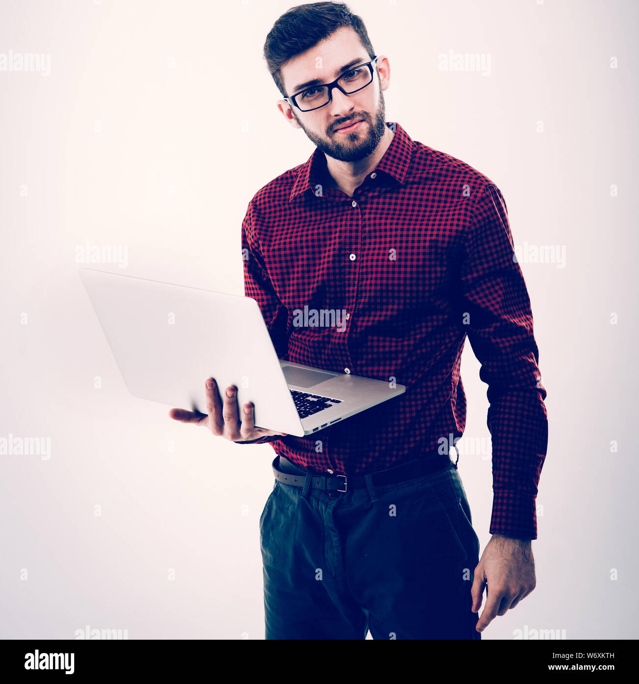system administrator with a laptop against white background.the photo ...