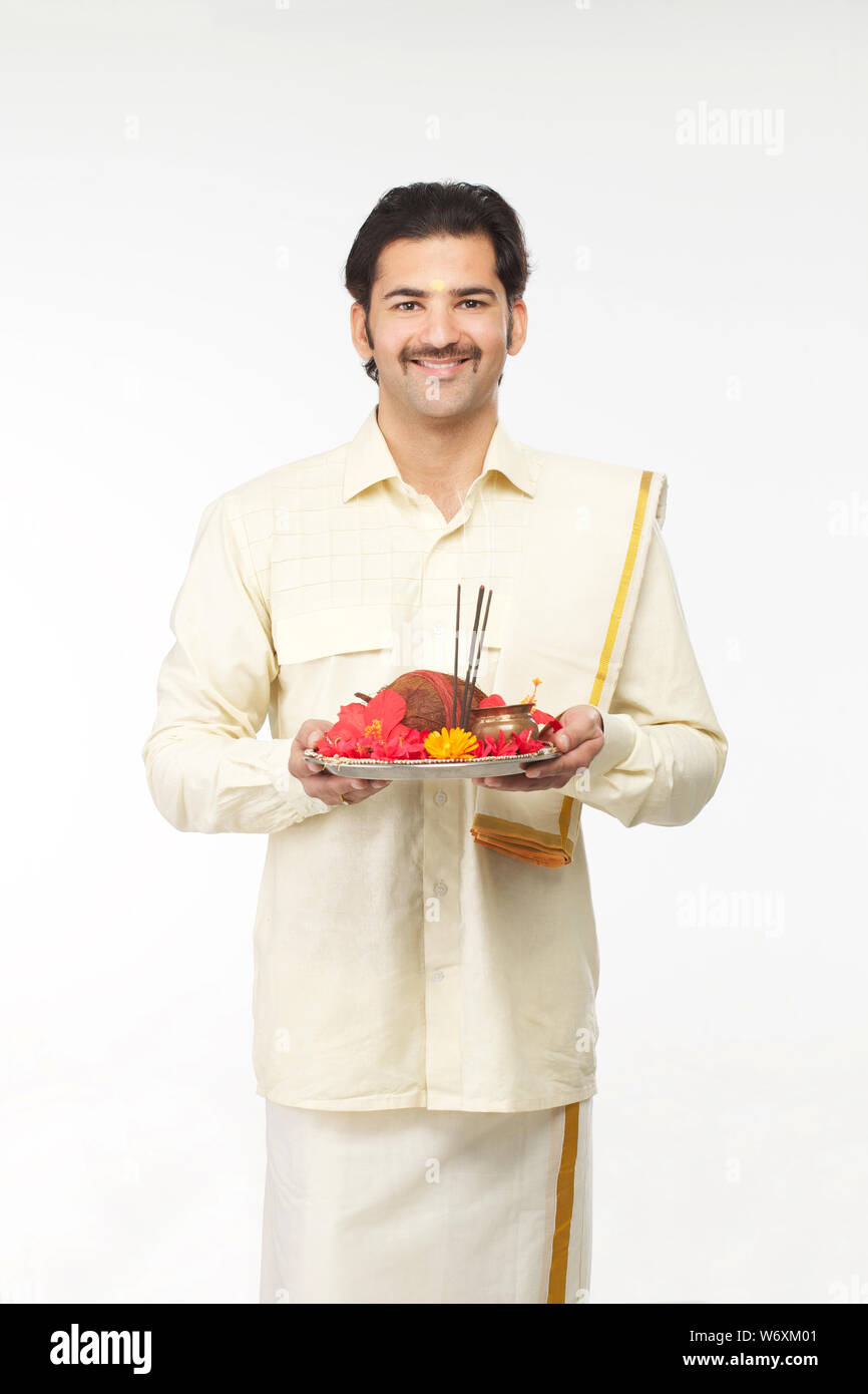 South Indian man holding puja thali Stock Photo - Alamy