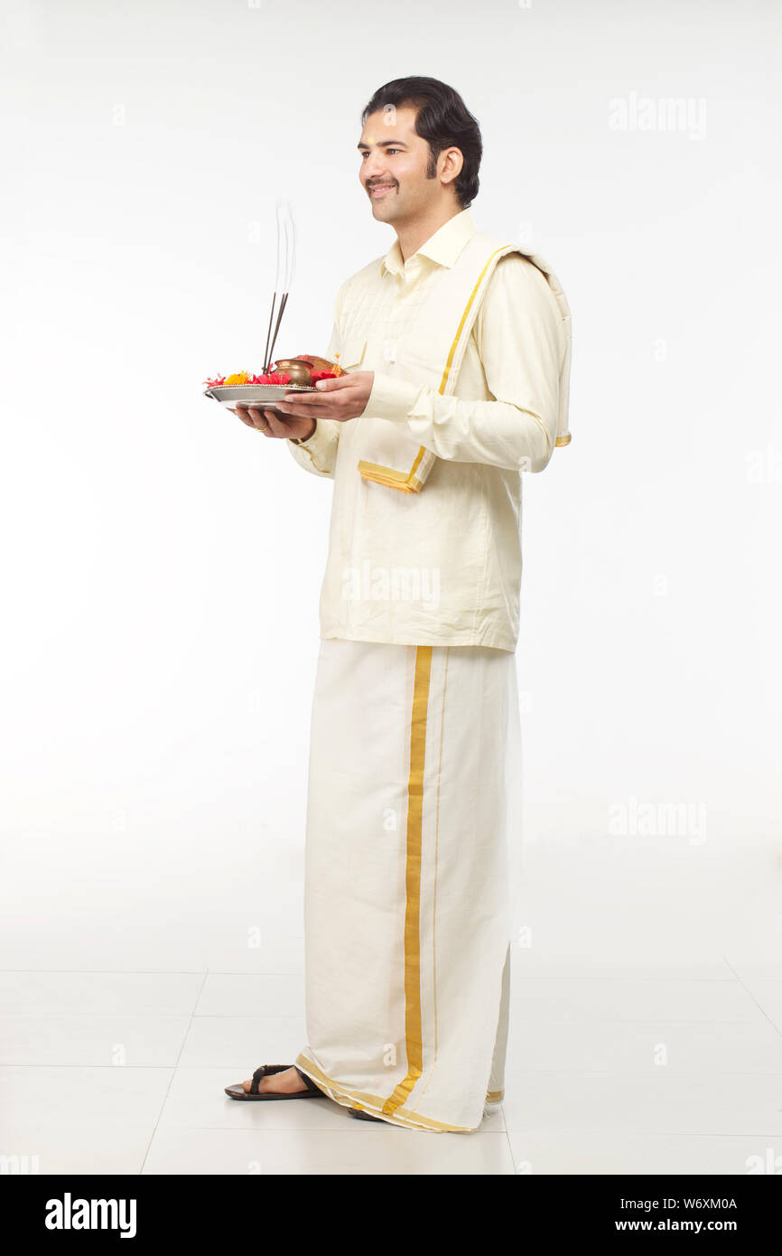 South Indian man holding puja thali Stock Photo - Alamy