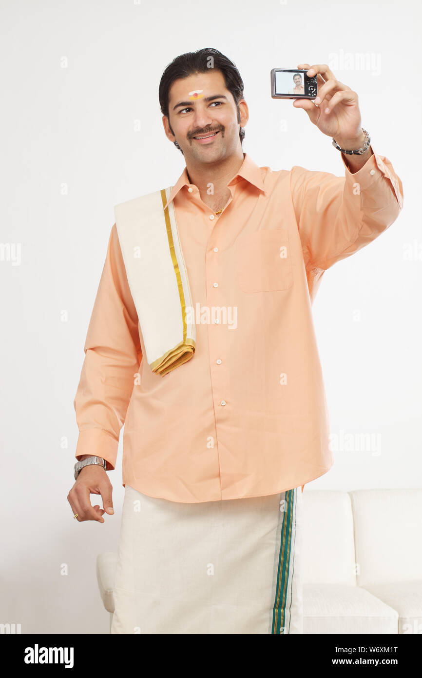 South Indian man taking picture with digital camera Stock Photo - Alamy