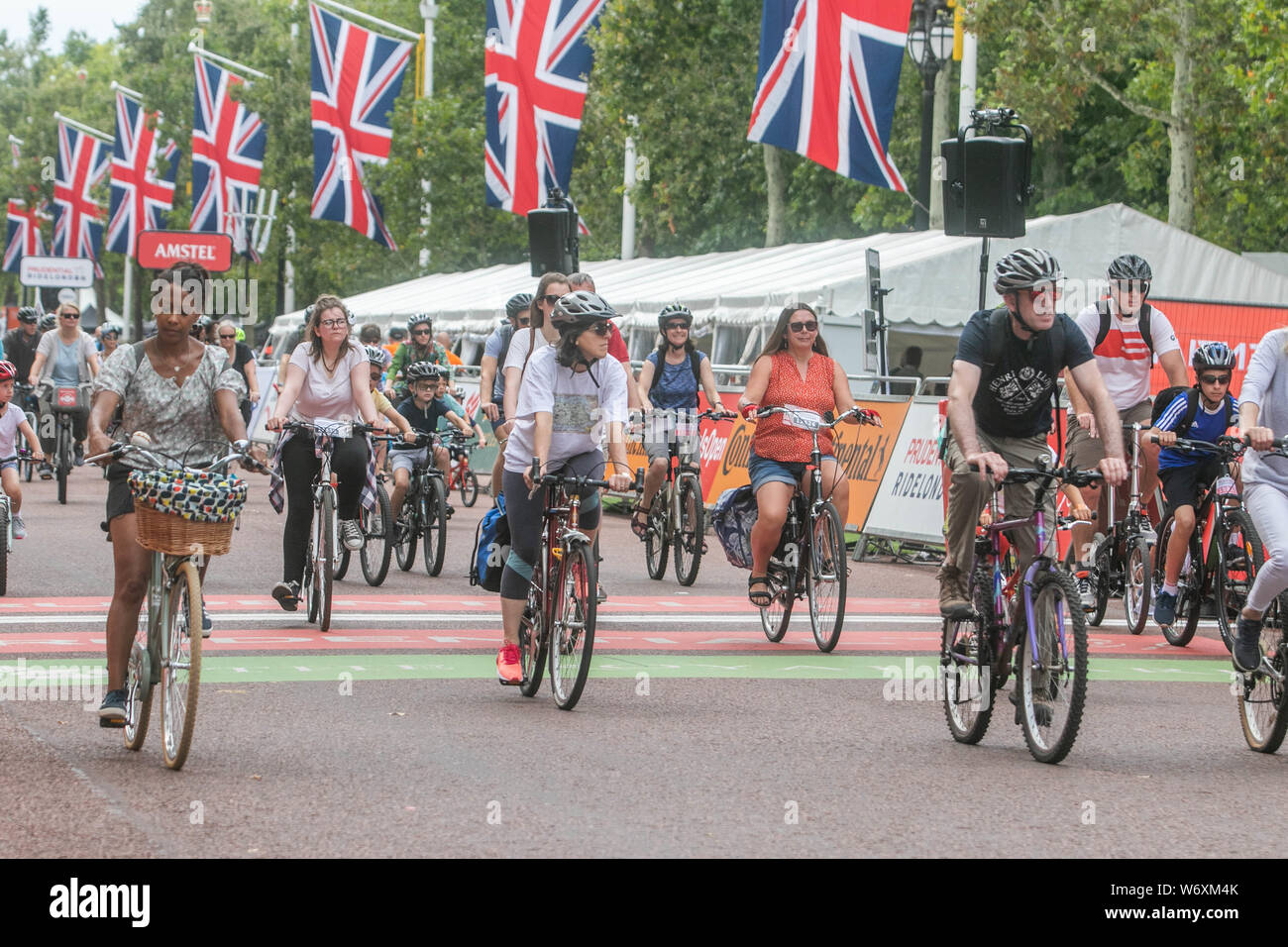 London, UK. 3rd August 2019. Cyclists riding down The Mall in the ...