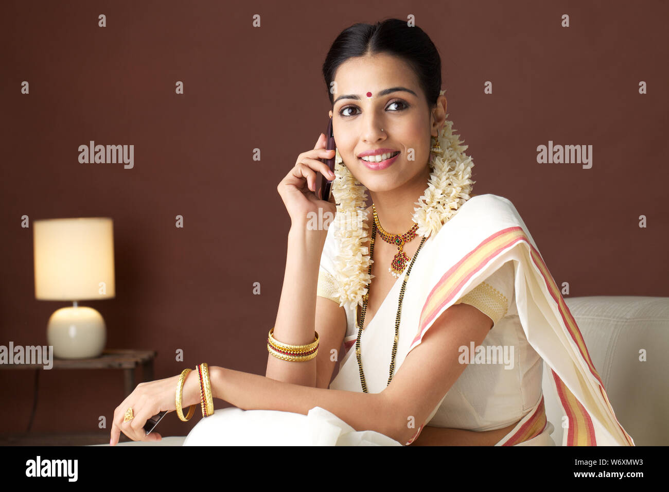South Indian woman talking on a mobile phone Stock Photo - Alamy