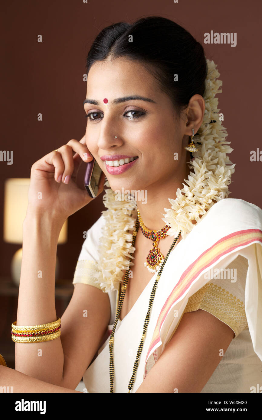 South Indian woman talking on a mobile phone Stock Photo - Alamy