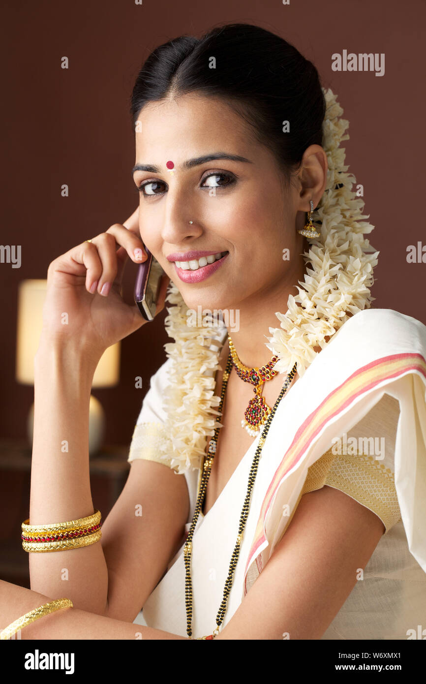 South Indian woman talking on a mobile phone Stock Photo - Alamy