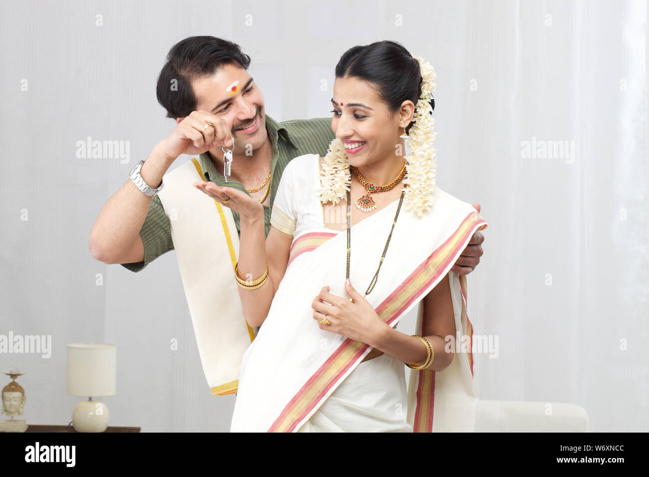 Man giving house keys to his wife and smiling Stock Photo - Alamy
