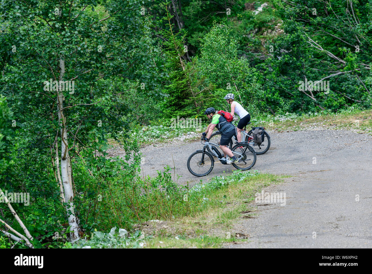 Steep downhill on small street with pedelecs Stock Photo - Alamy