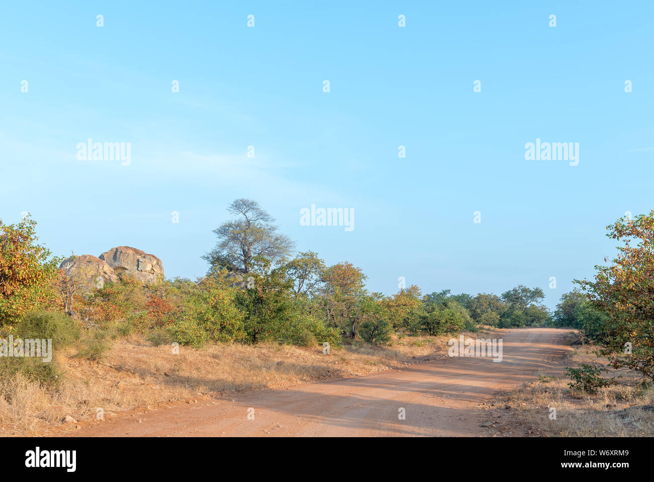An Autumn landscape with a gravel road and rocky outcrop Stock Photo ...