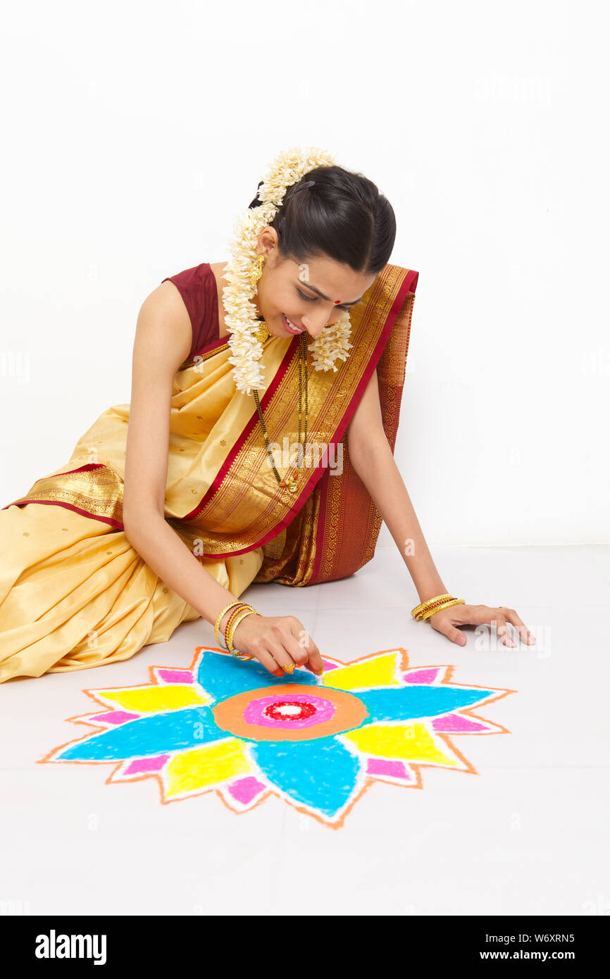 South Indian woman making a rangoli Stock Photo - Alamy