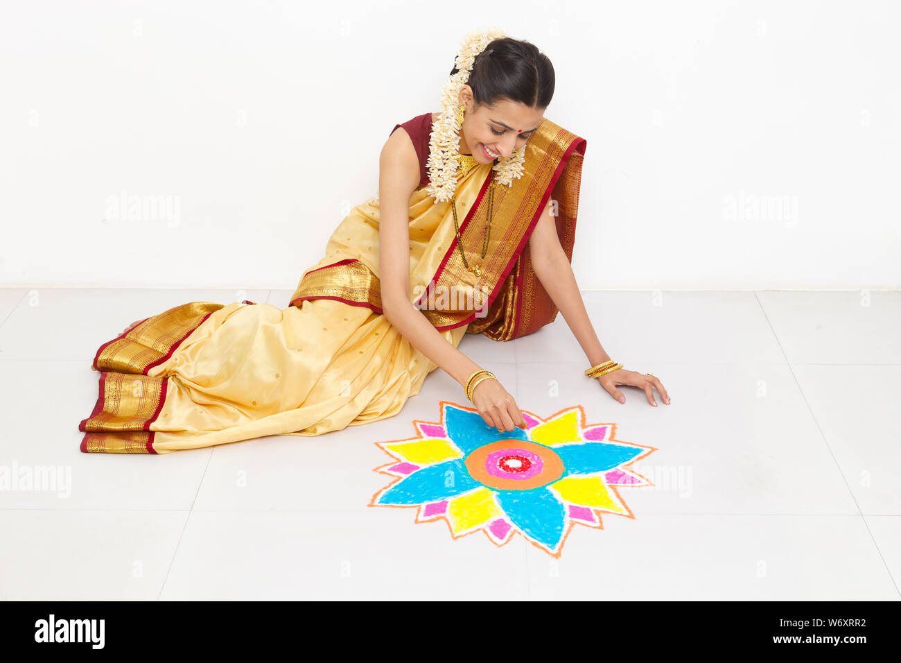 South Indian woman making a rangoli Stock Photo - Alamy