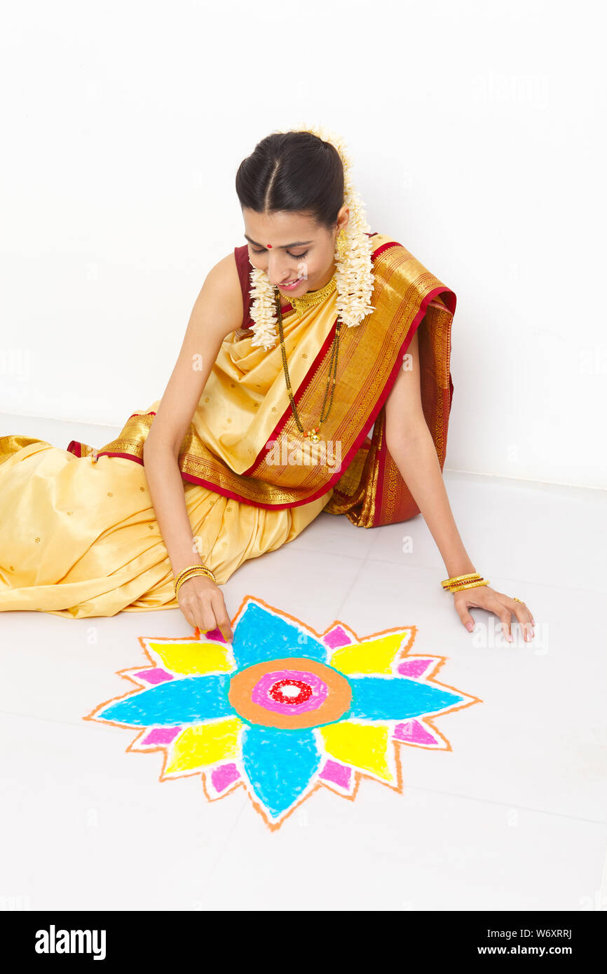South Indian woman making a rangoli Stock Photo - Alamy